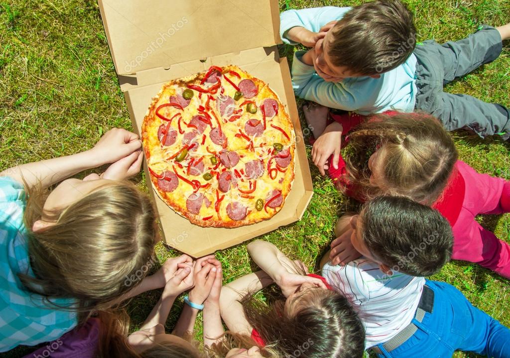Children eating pizza Stock Photo by ©Katkov 78730476