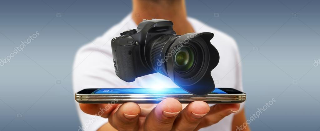 Young man using modern camera — Stock Photo © sdecoret #102156790
