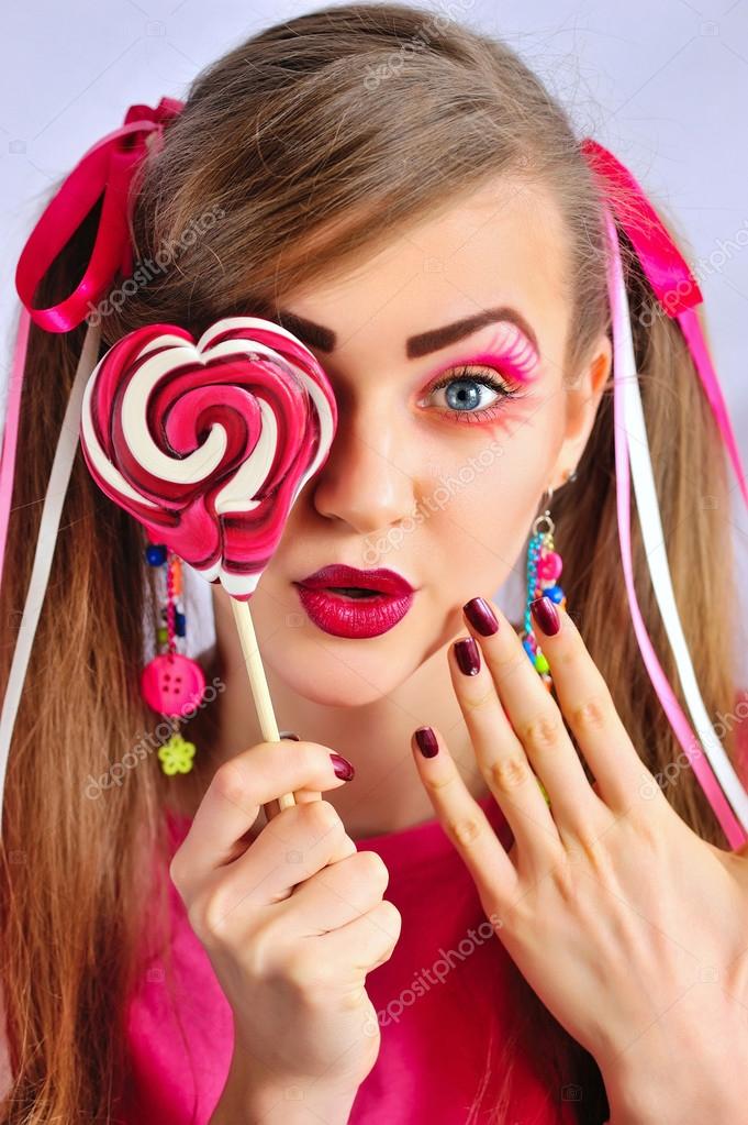 Beautiful girl with creative makeup with colorful lollipop Stock Photo ...