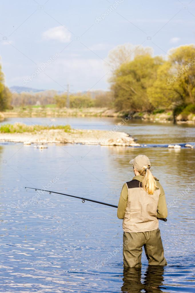 Woman fishing in the river in spring — Stock Photo © phb.cz #75974549
