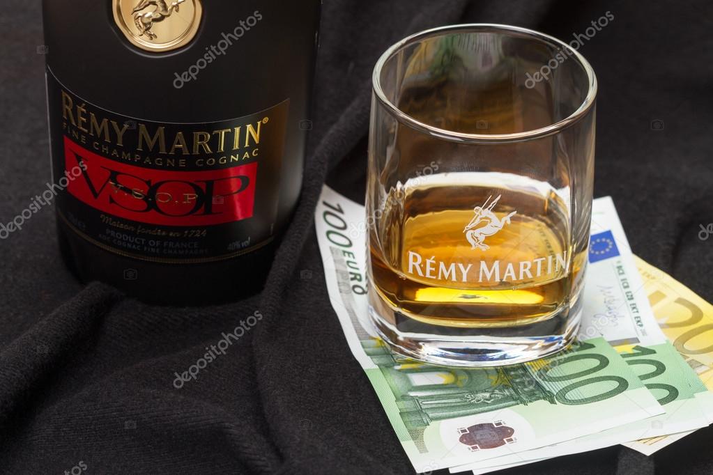 Glass cognac Remy Martin and euro banknotes — Stock Editorial Photo ...