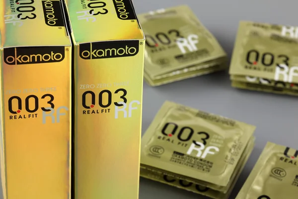 Okamoto 003 Real Fit condoms with boxes - Stock Image - Everypixel