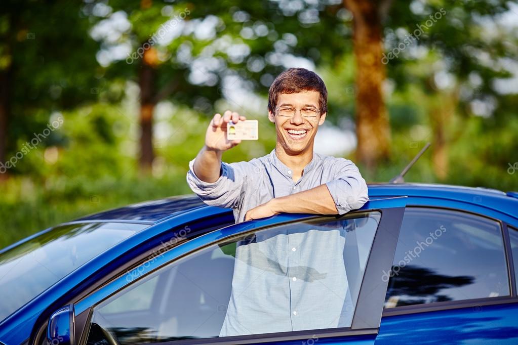Guy with driving license Stock Photo by ©furtaev 95628346