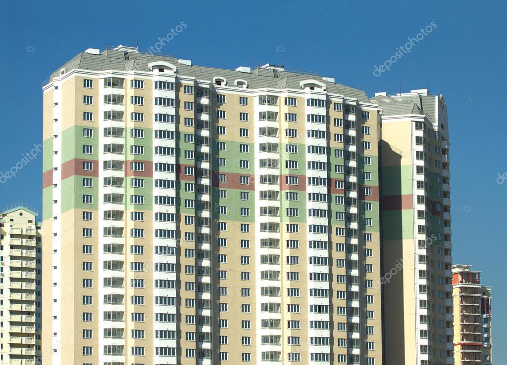 New built modern apartment building of brick with a clear blue sky ...