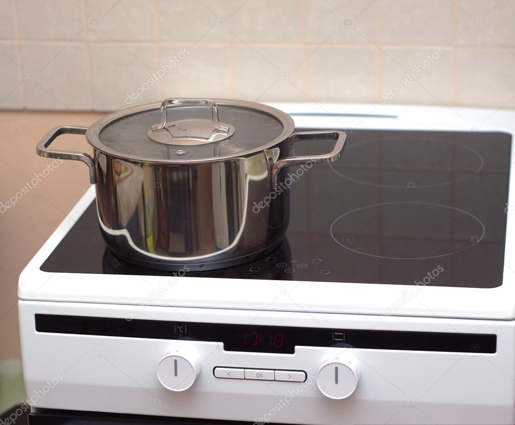 Metal steel saucepan on modern kitchen electric stove — Stock Photo ...
