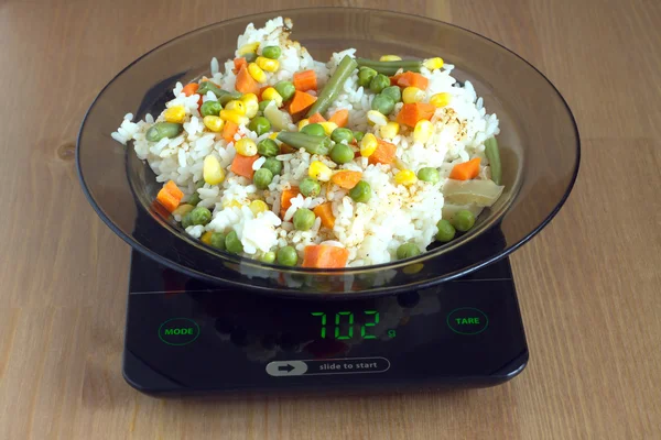 Plate with rise and vegetables on kitchen scales closeup - Stock Image ...