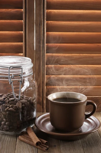 Hot coffee against shutters — Stock Photo © svl861 #90325734