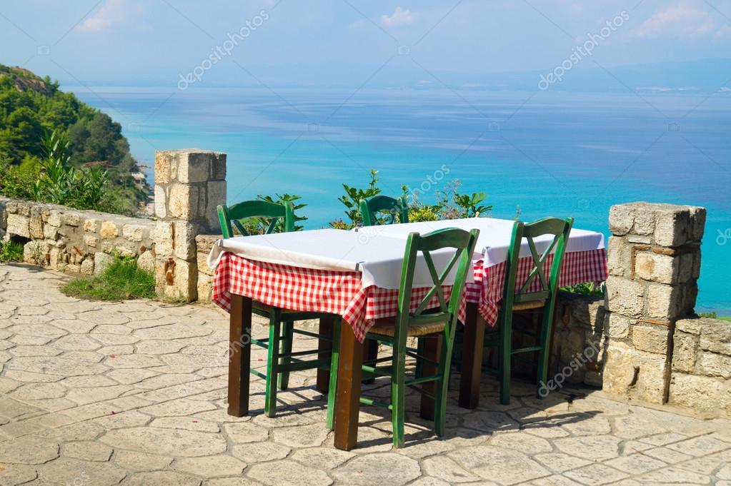 Traditional Greek table at the beach in Greece — Stock Photo ...