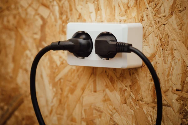 AC power plug and socket, wooden osb wall background Stock Photo by ...