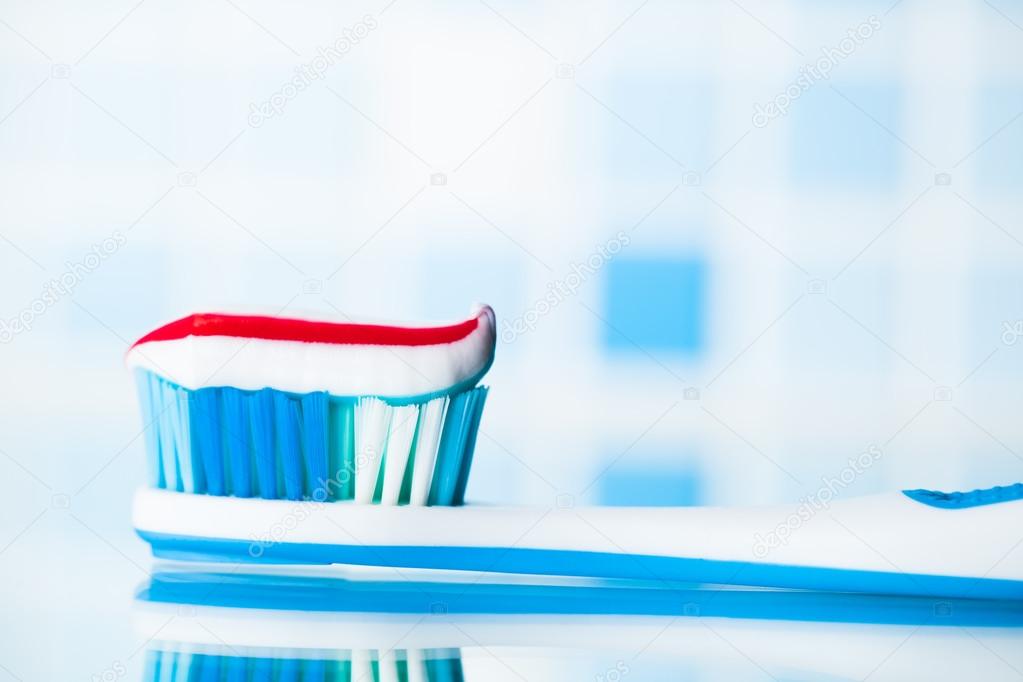 Toothbrush with red stripe toothpaste Stock Photo by ©nikkytok 123658464