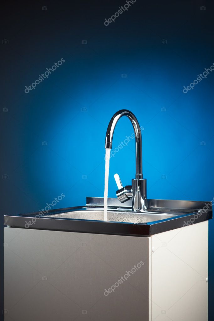Mixer tap with flowing water, blue background Stock Photo by ©nikkytok ...