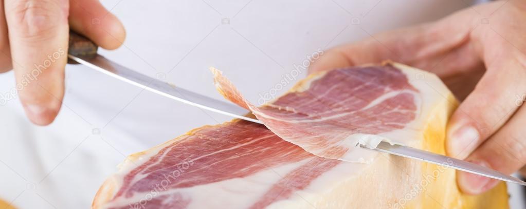 Professional cutting of serrano ham — Stock Photo © angelsimon #68888045