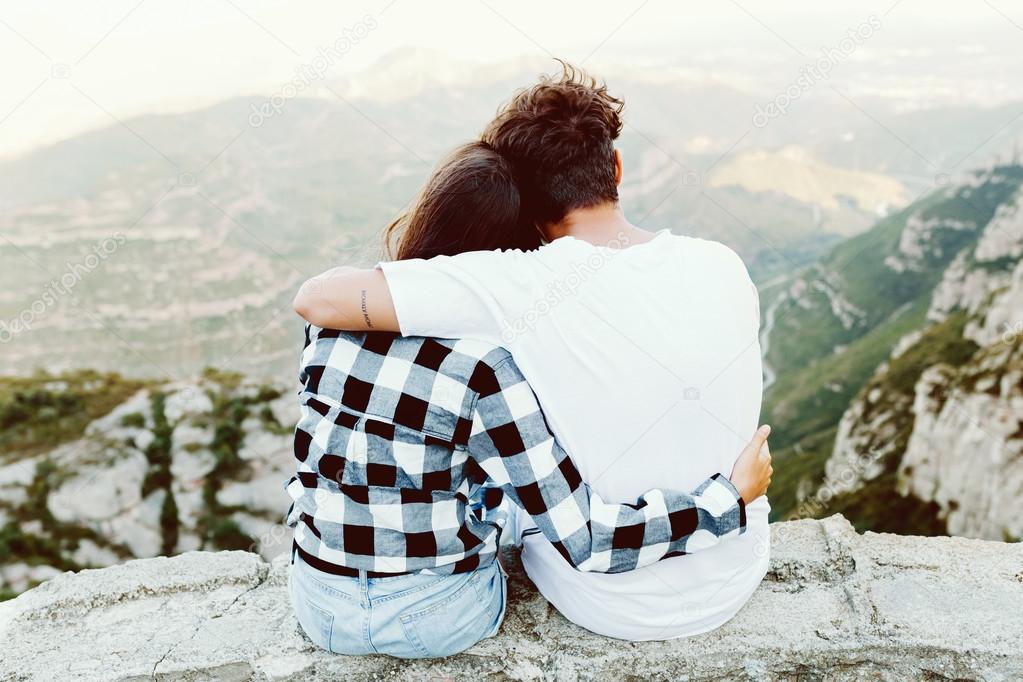 Beautiful young couple enjoying nature at mountain peak. Stock Photo by ©nenetus 122785968