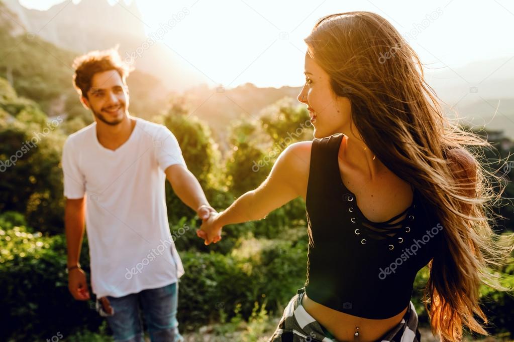 Beautiful young couple enjoying nature at mountain peak. Stock Photo by ©nenetus 122788072