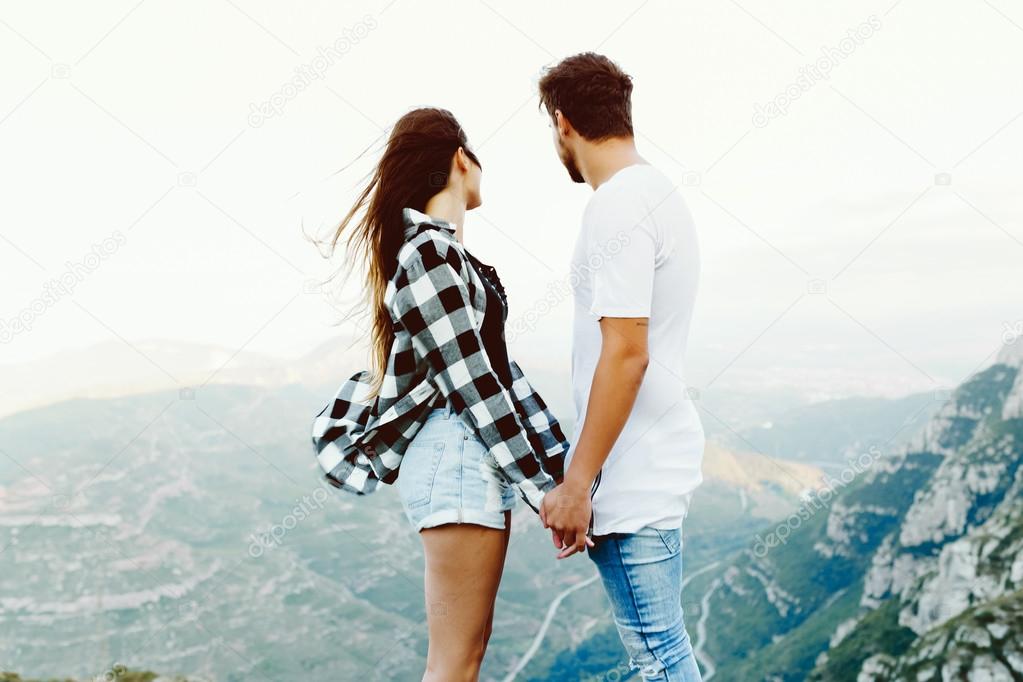 Beautiful young couple enjoying nature at mountain peak. — Stock Photo © nenetus #122792510