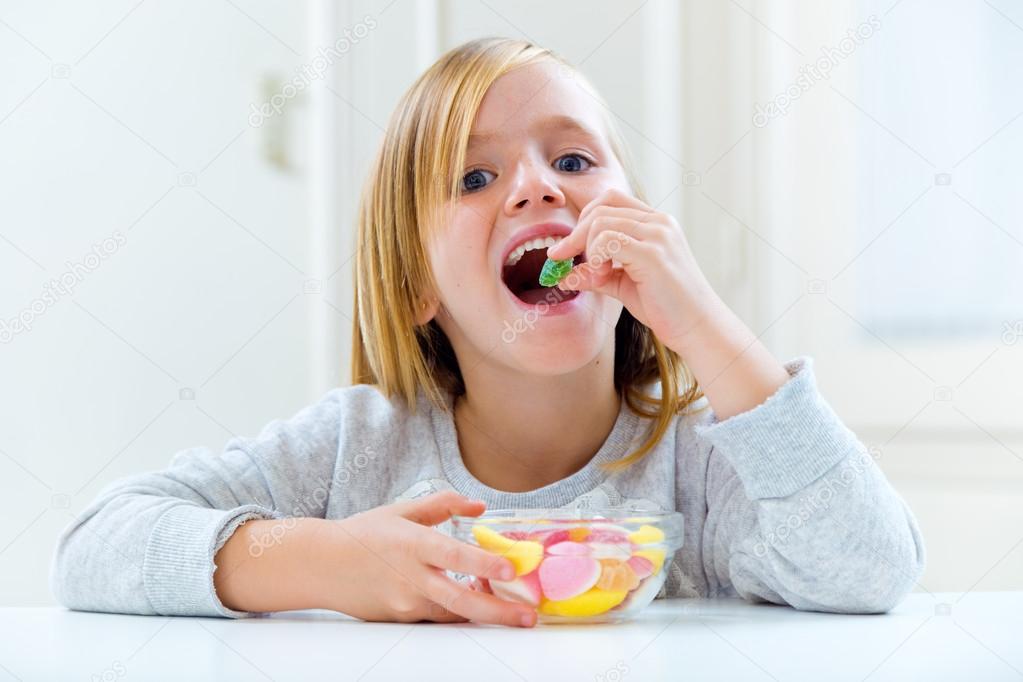 Beautiful child eating sweets at home. — Stock Photo © nenetus #56851333