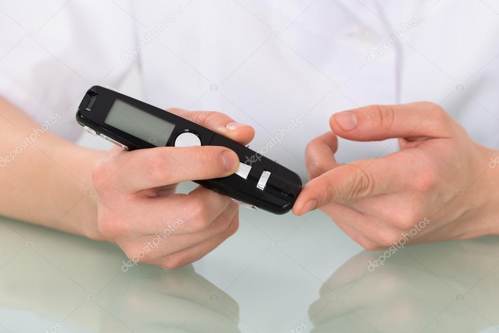 Patient Checking Blood Sugar Level Stock Photo by ©AndreyPopov 103745890