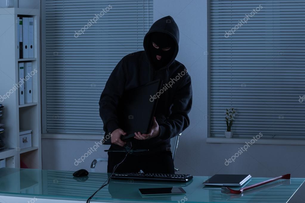 Thief Stealing Computer Stock Photo by ©AndreyPopov 104931662