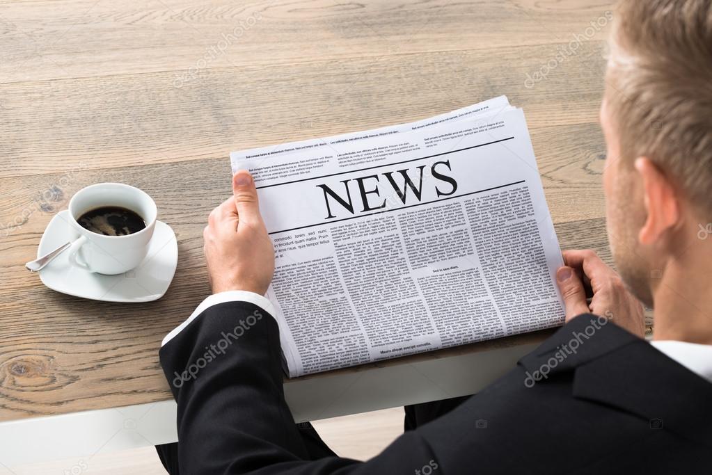 Businessman Reading Newspaper Stock Photo by ©AndreyPopov 107784668