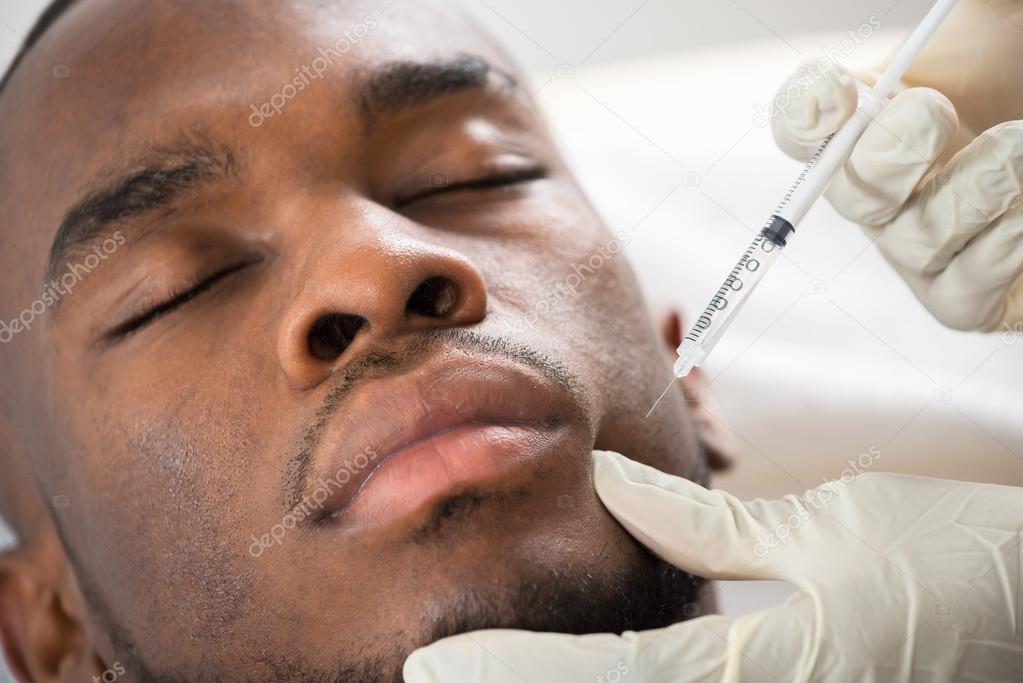 Injecting Syringe On Young Man — Stock Photo © AndreyPopov #107795904