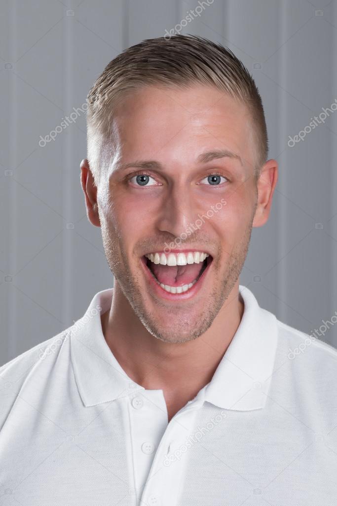 Young Handsome Man Laughing — Stock Photo © AndreyPopov #110429330