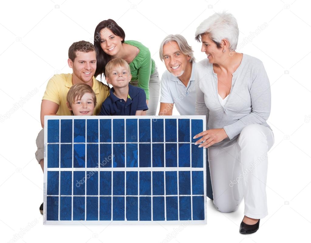 Happy Family Holding Solar Panel Stock Photo by ©AndreyPopov 110429374