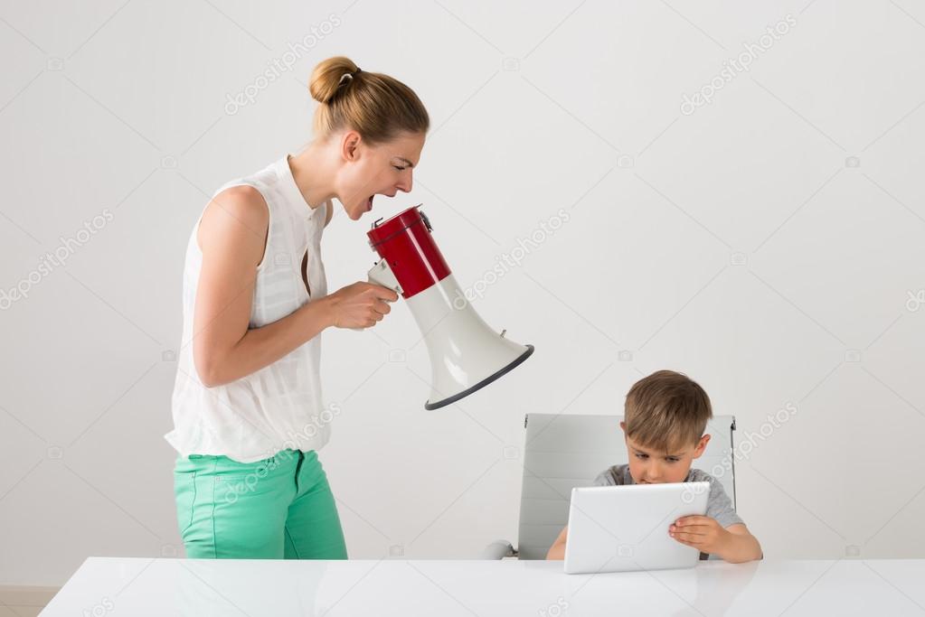 Frustrated Mother Shouting At Her Boy Stock Photo by ©AndreyPopov 115963516