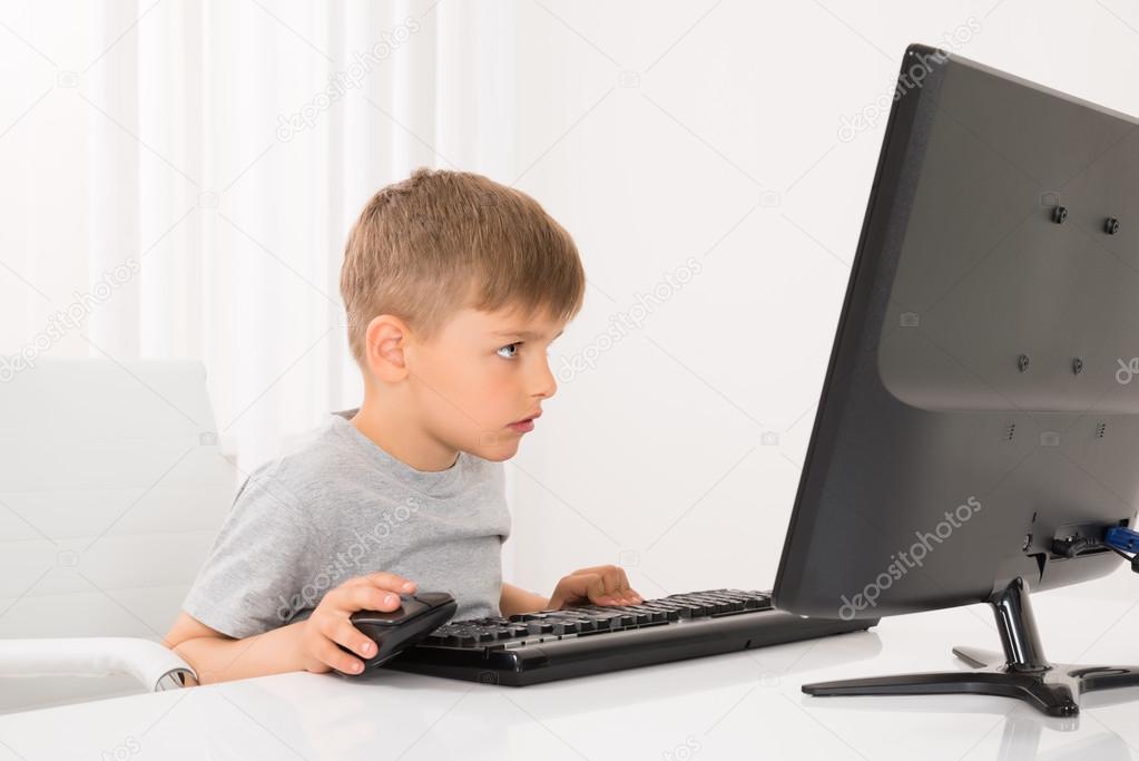 Boy Using Computer Stock Photo by ©AndreyPopov 117549164