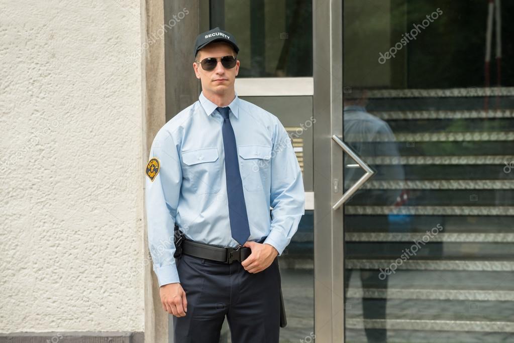 Male Security Guard Standing At The Entrance — Stock Photo ...