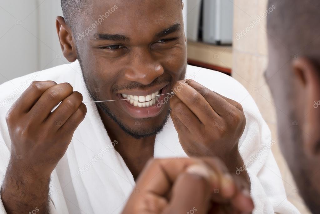African Man Cleaning His Teeth — Stock Photo © AndreyPopov #119318728