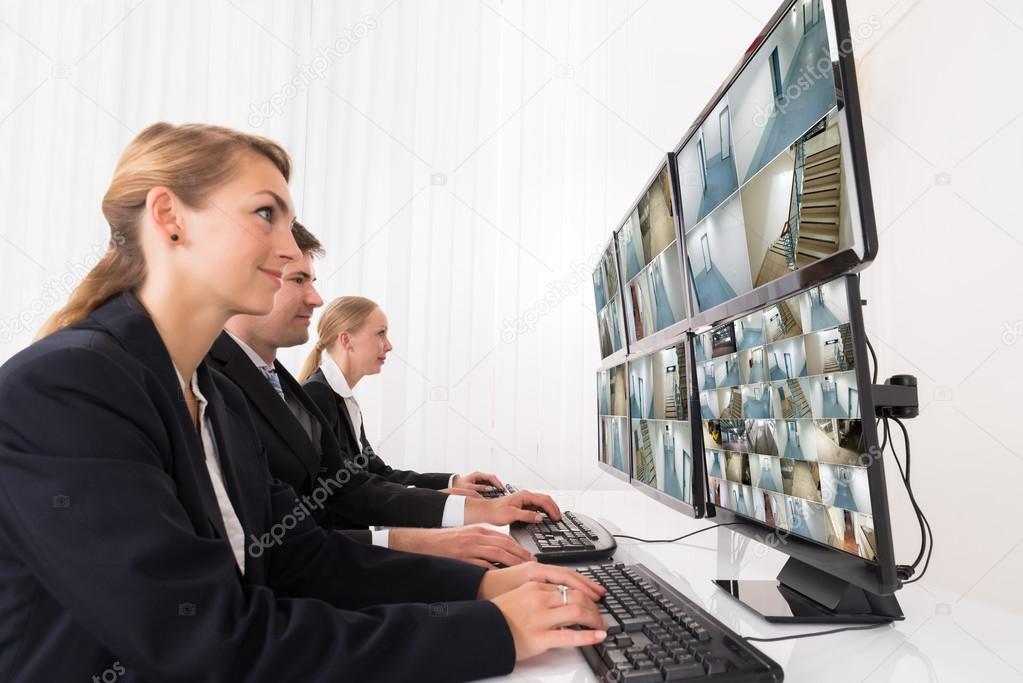 Security System Operators Looking At CCTV Footage Stock Photo by ...