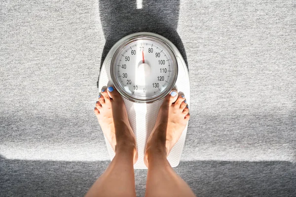 Woman Measuring Weight On Weighing Scale — Stock Photo © AndreyPopov ...