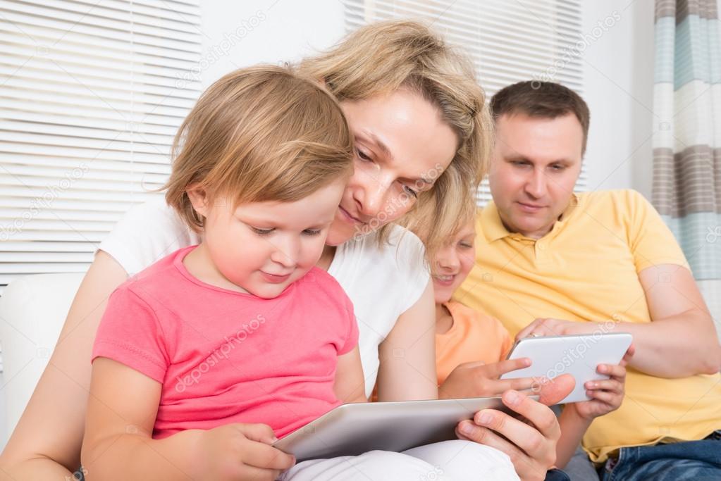 Young Family Using Tablet Together Stock Photo by ©AndreyPopov 53302319
