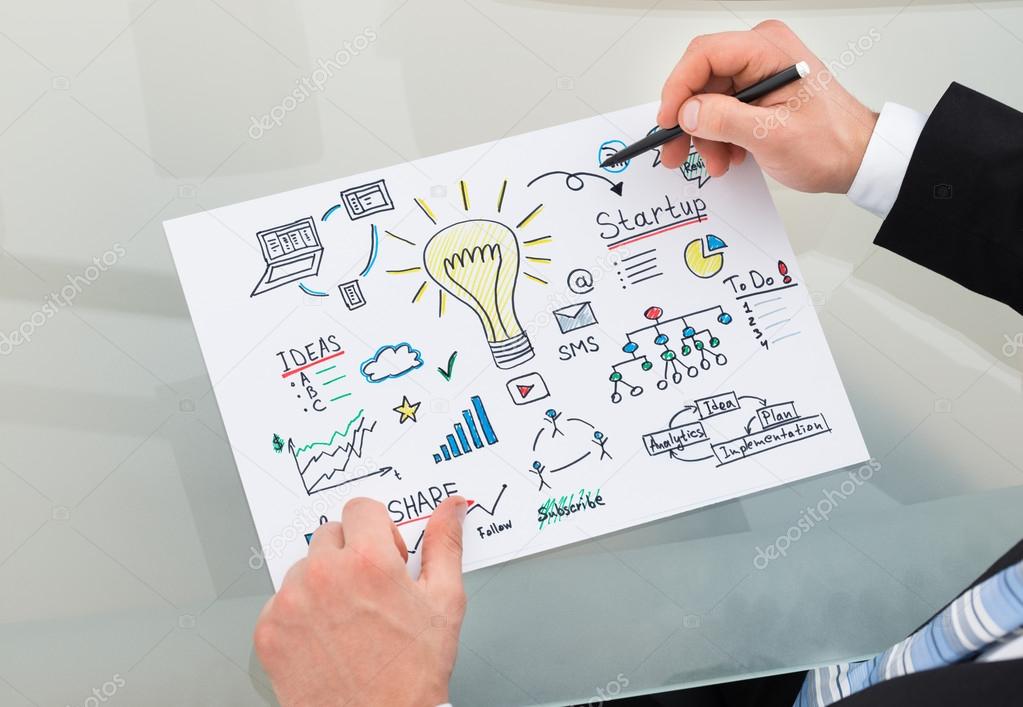 Businessman Drawing Management Chart At Desk Stock Photo by ...