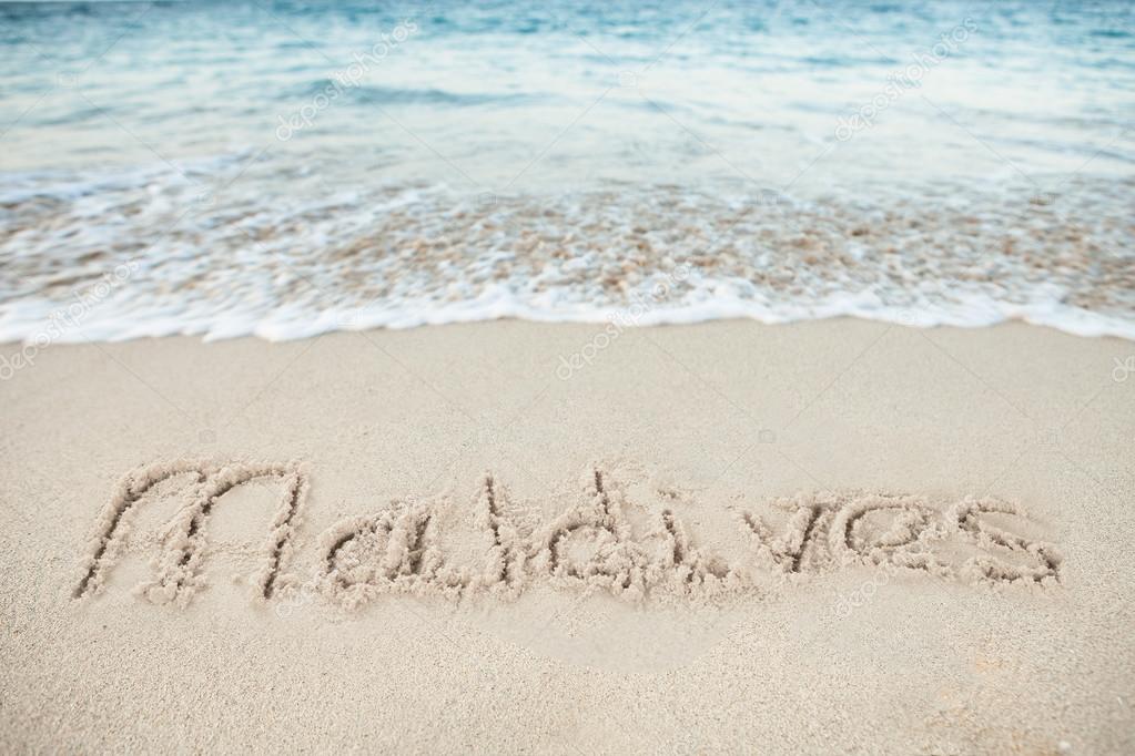 Maldives Written On Sand — Stock Photo © AndreyPopov #65675331