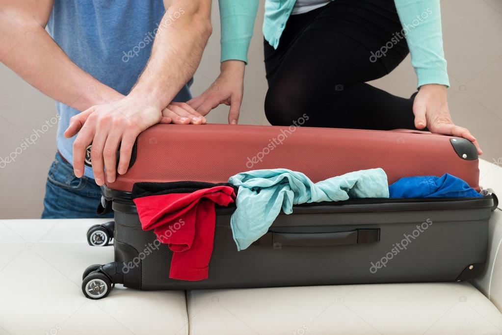 Couple Together Packing Luggage — Stock Photo © AndreyPopov #70804409