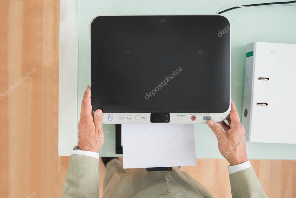 Businessman Using Photocopy Machine — Stock Photo © AndreyPopov #72078757