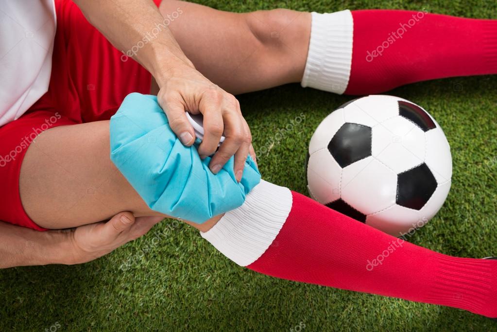 Soccer Player Icing Knee Stock Photo by ©AndreyPopov 73538407