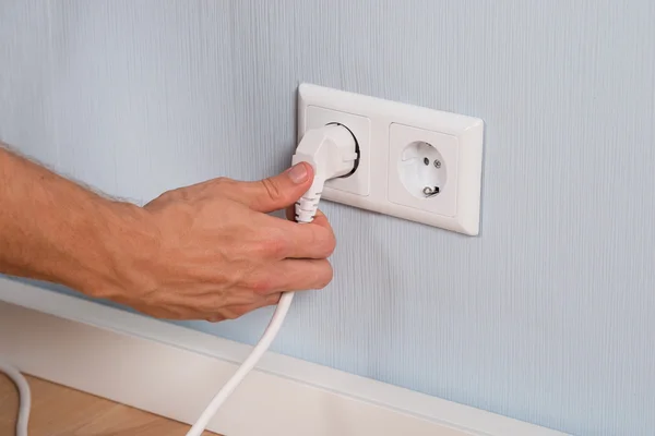 Hand Inserting Electrical Plug — Stock Photo © AndreyPopov #74747285