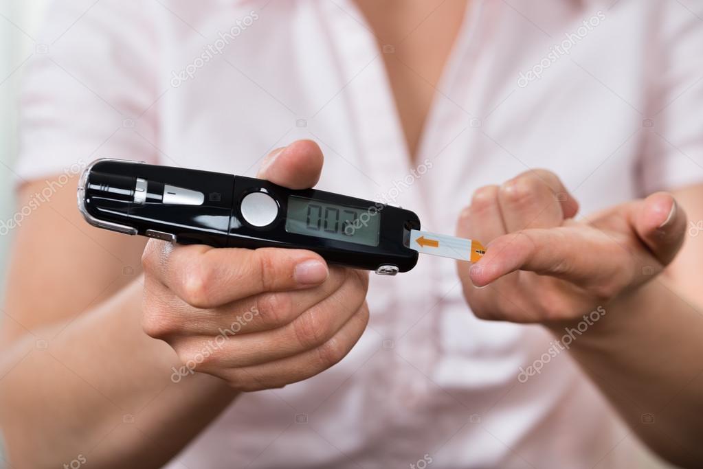 Hands Holding Glucometer Stock Photo by ©AndreyPopov 77903074