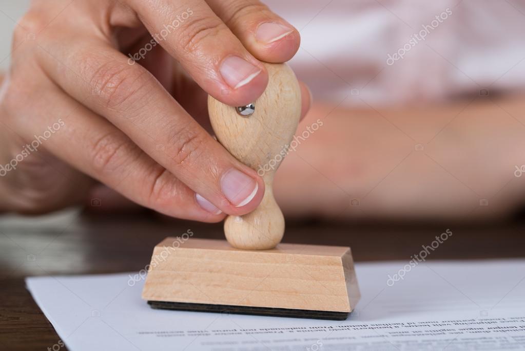 Hands With Stamper And Document — Stock Photo © AndreyPopov #77903114