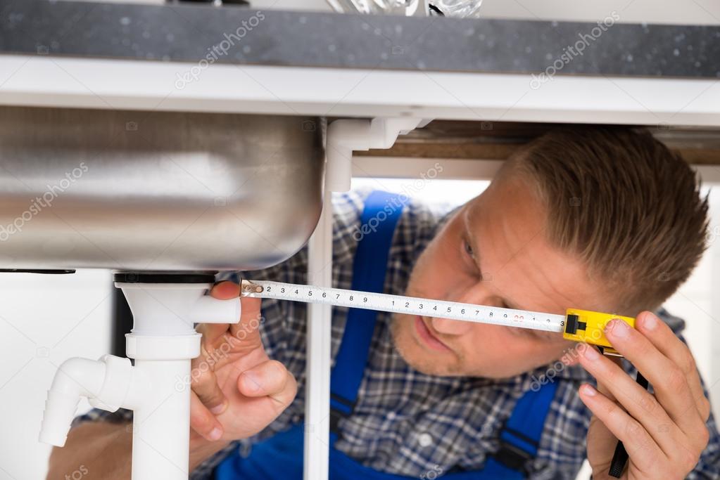 Plumber Measuring Sink Pipe Stock Photo by ©AndreyPopov 80377874