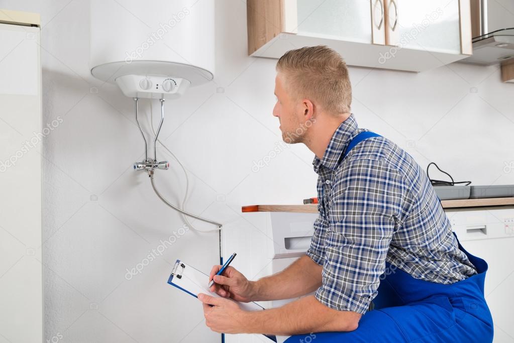 Plumber Writing On Clipboard — Stock Photo © AndreyPopov #80939450