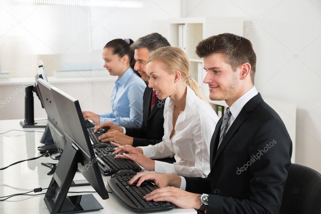 Businesspeople Typing On Desktop Computers — Stock Photo © AndreyPopov ...