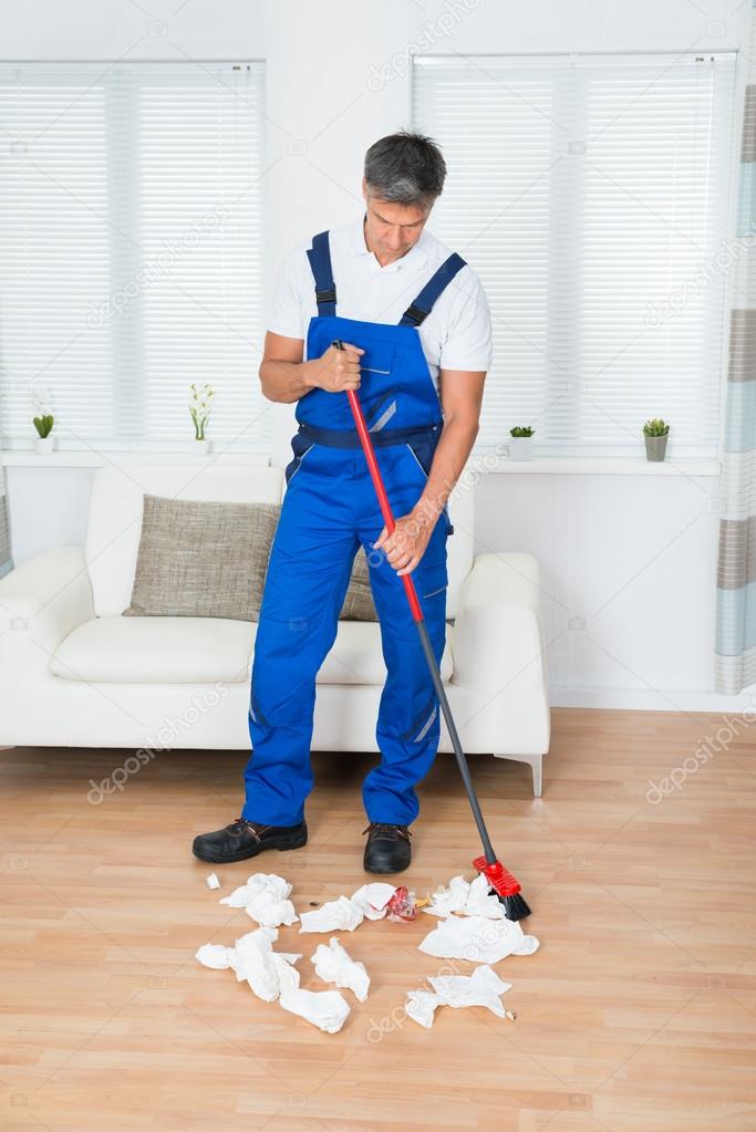 Man Sweeping The Floor