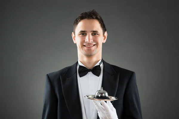 Smiling Waiter Holding Service Bell Stock Photo by ©AndreyPopov 95378060