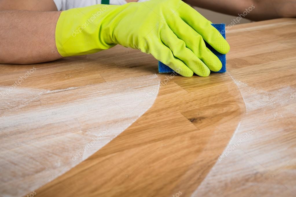 Man Cleaning Dust On Wooden Table Stock Photo by ©AndreyPopov 95377976