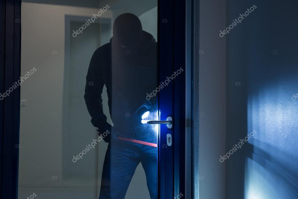 Burglar Using Crowbar To Open Door Stock Photo by ©AndreyPopov 95378300