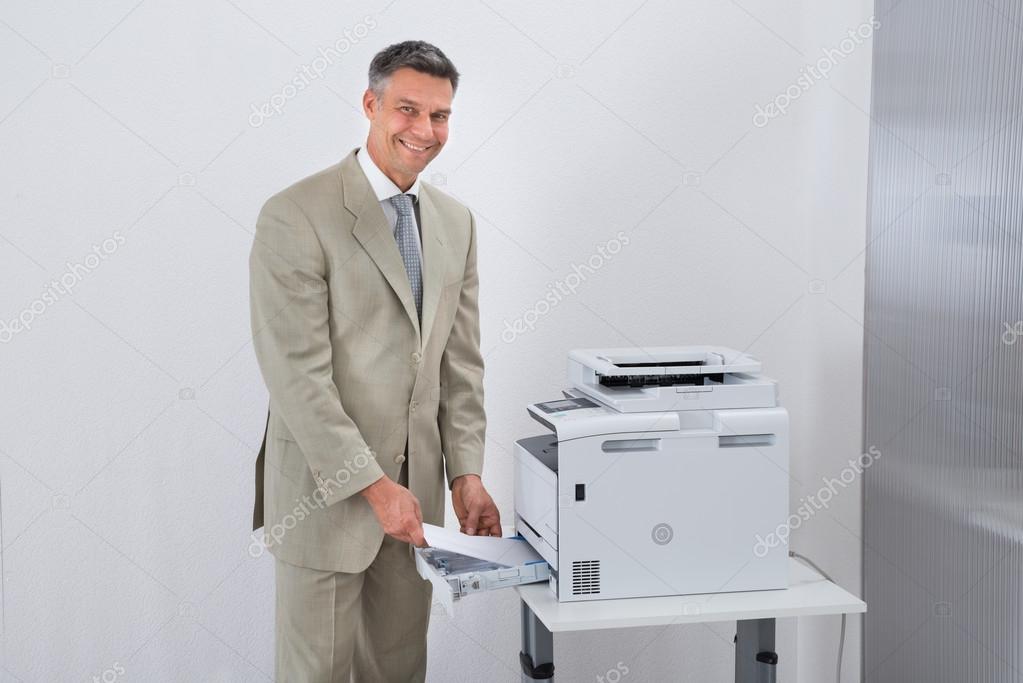 Confident Businessman Using Printer In Office — Stock Photo ...