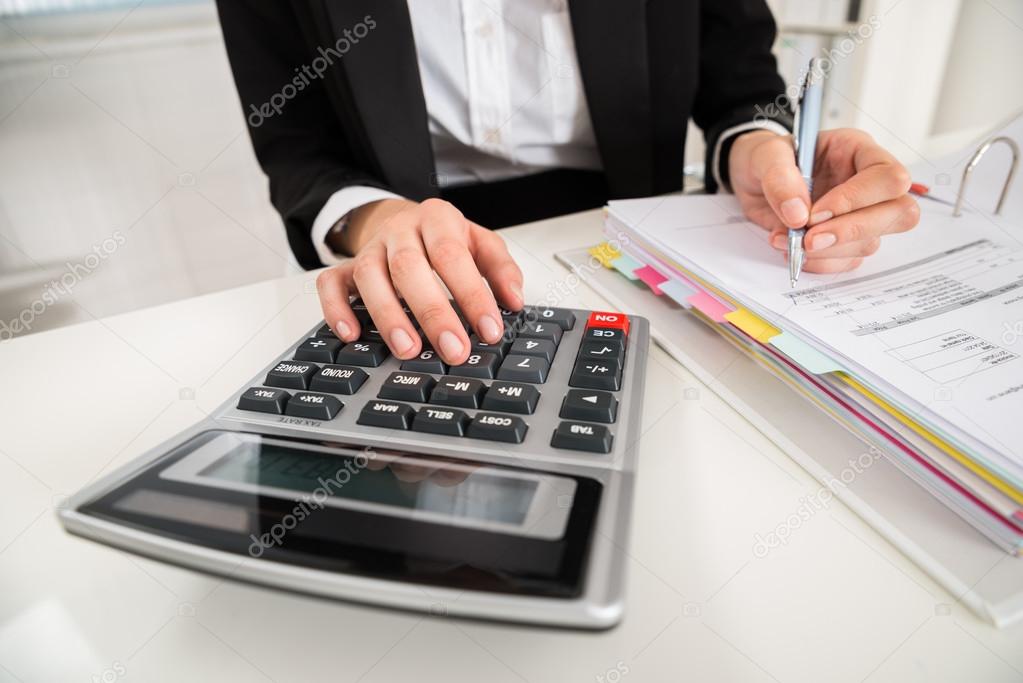 Businesswoman Doing Financial Calculation At Desk — Stock Photo ...